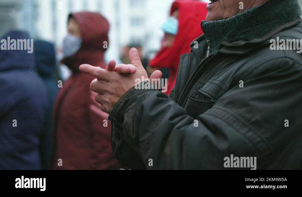 Angry crowd on city square claps to cheer up each other and show ...