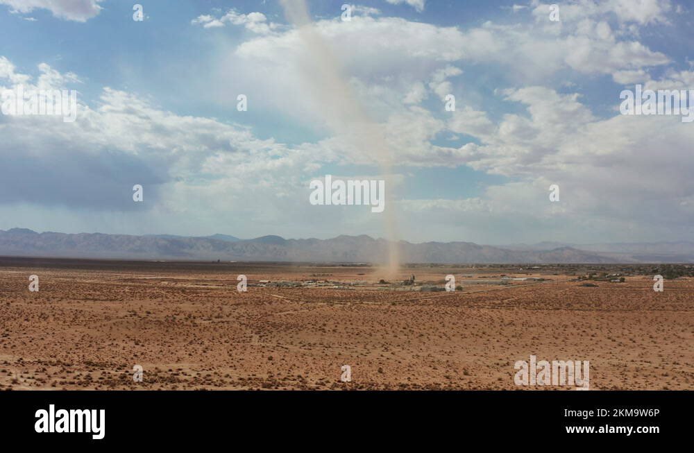 A sandstorm or dust devil with spinning wind send a dust cloud in the ...