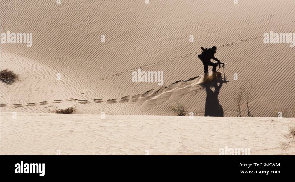 Futuristic apocalyptic soldier walks and struggles in sand dunes in ...