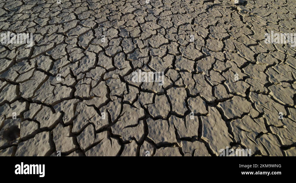 Climate change.Aerial fly over view of cracked mud surface of a dry dam ...
