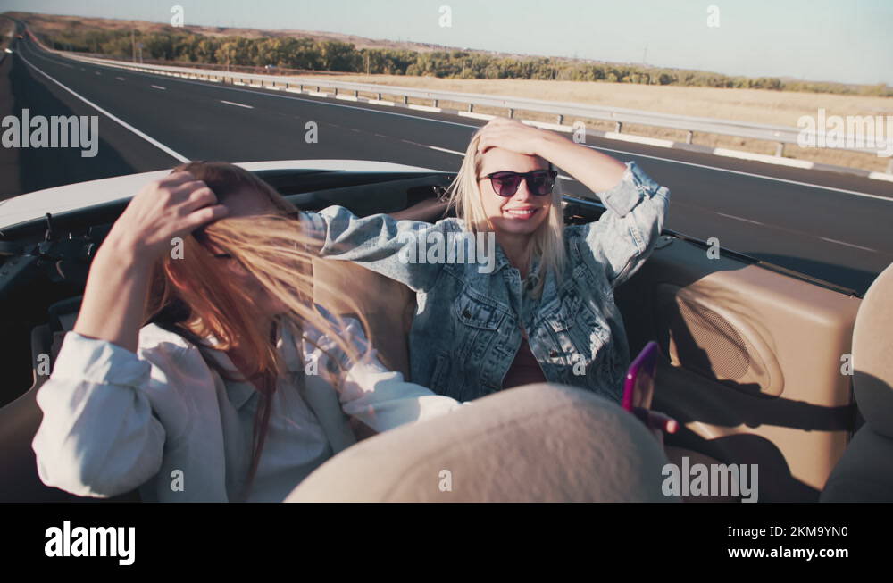 Group of friends driving off road convertible car during roadtrip ...