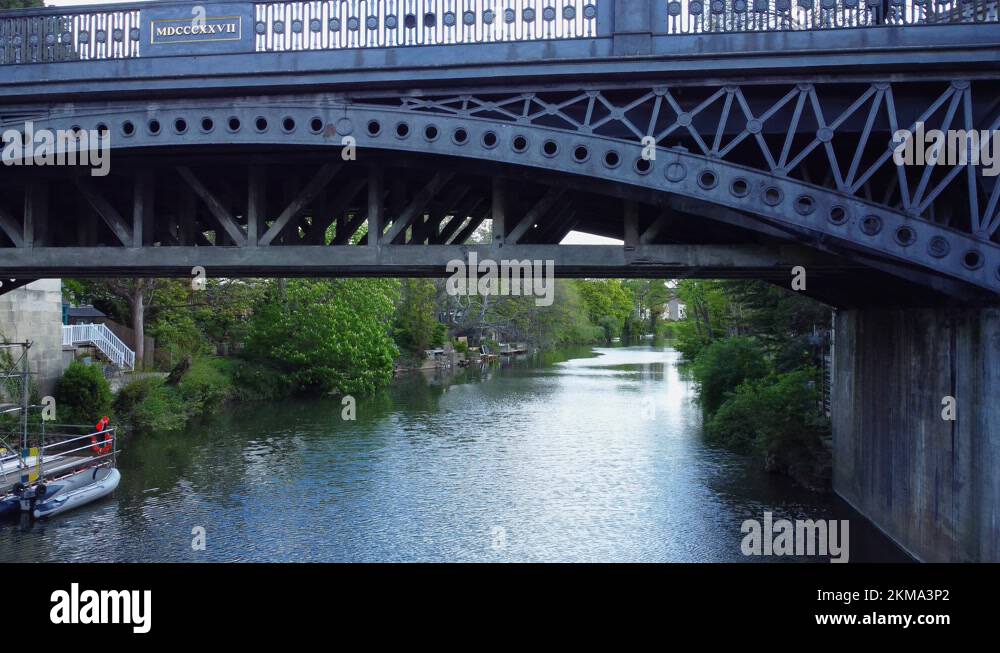 Maintenance work takes place on the underside of a bridge. Engineers in ...