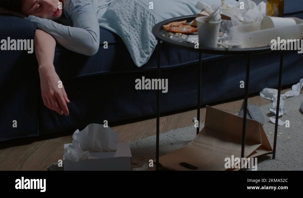 Depressed woman lying alone on sofa feeling tired vulnerable weak ...