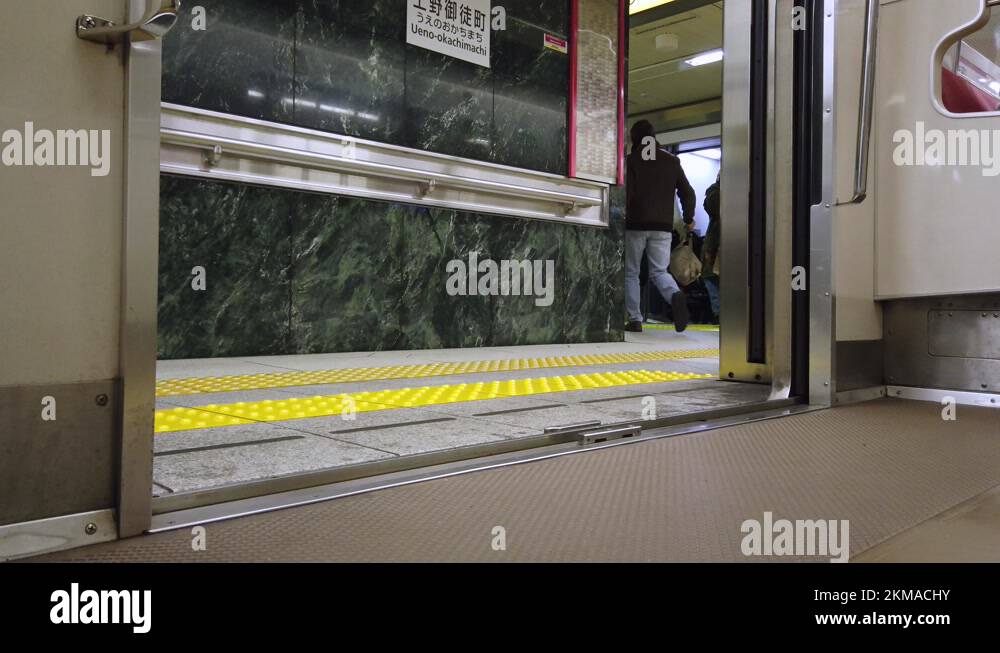 POV to the commuter train door while train is at platform in subway ...