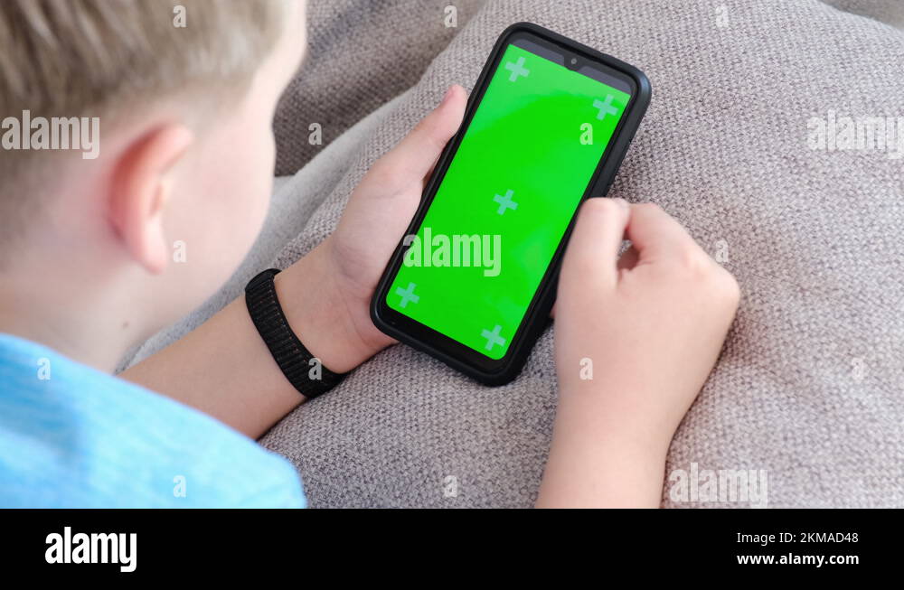 4K Boy Holding his Smartphone with Green Screen, Scrolling Touching ...