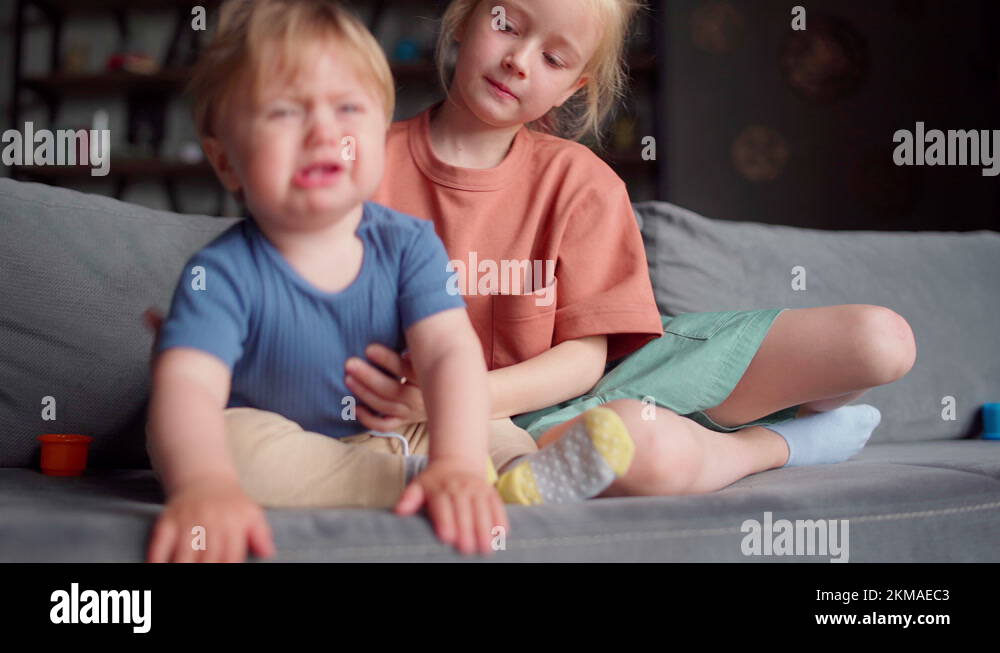 Little elder sister soothing crying baby brother Stock Video Footage ...