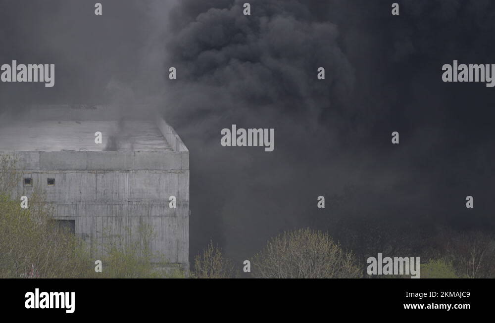 Powerful fire during construction school building. Strong black smoke ...