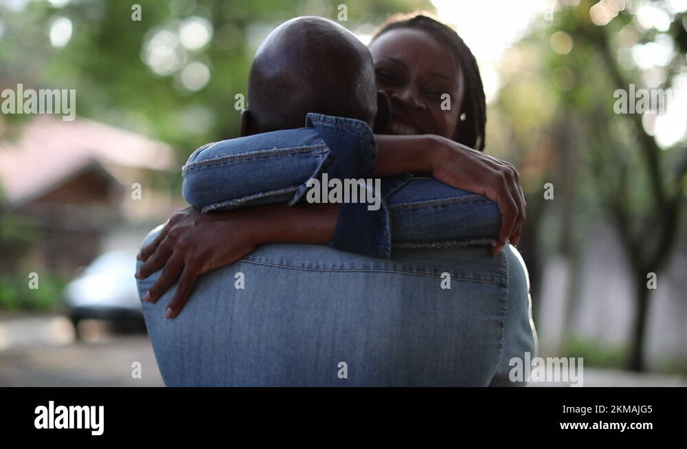 African couple hug, woman running towards partner embrace. Girl hugging ...