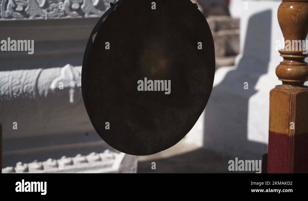 Hitting a gong in a sacred temple in Myanmar Stock Video Footage - Alamy
