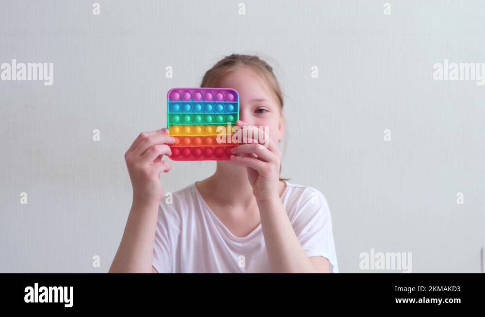 Teenage girl playing with rainbow popit. Modern silicone toy, trend 2021 Stock Video Footage - Alamy