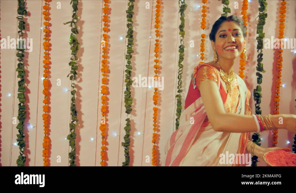 A cheerful Bengali lady playing with Sindur (Sindur Khela) during Durga ...