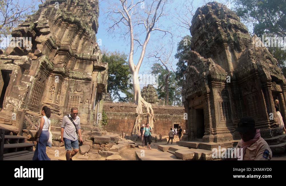 Inside one of the most famous temples of Cambodia, tourists walk among ...