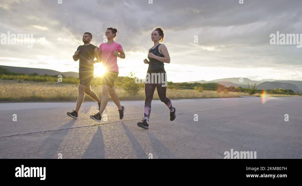Multiethnic group of athletes running together on a panoramic ...