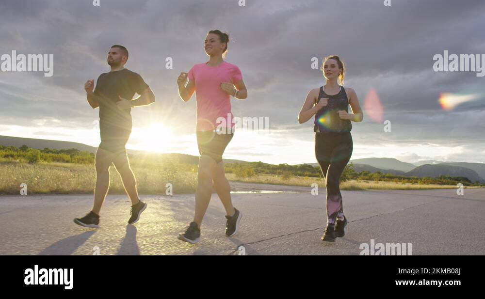 Multiethnic group of athletes running together on a panoramic ...