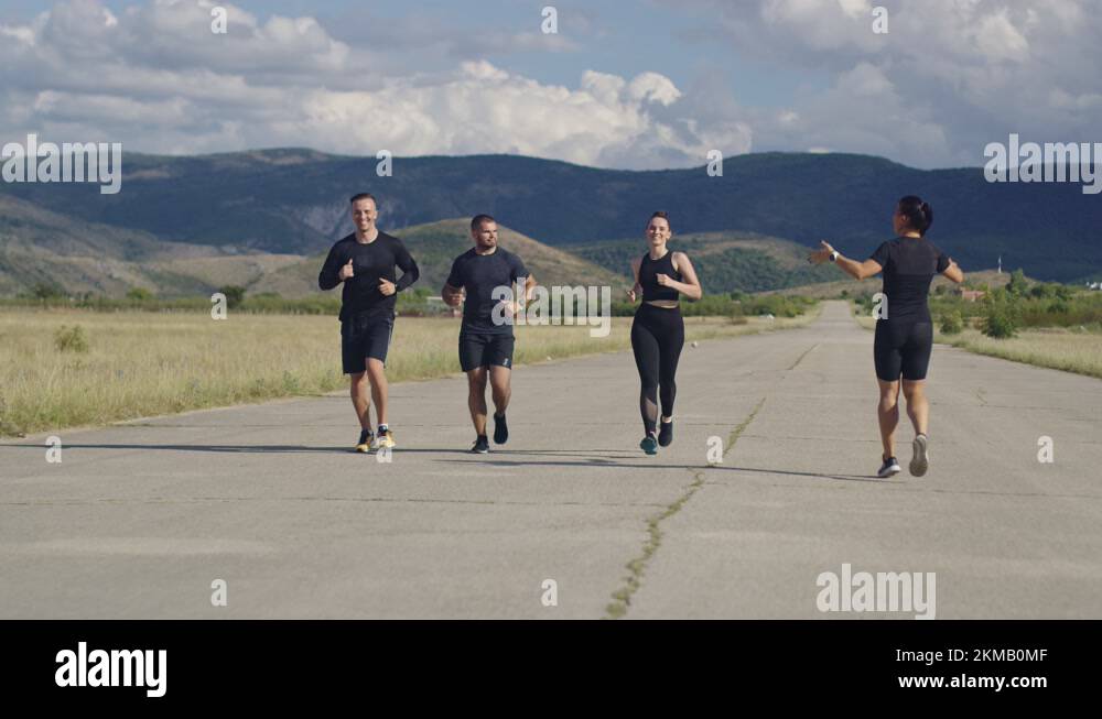 Multiethnic group of athletes running together on a panoramic ...