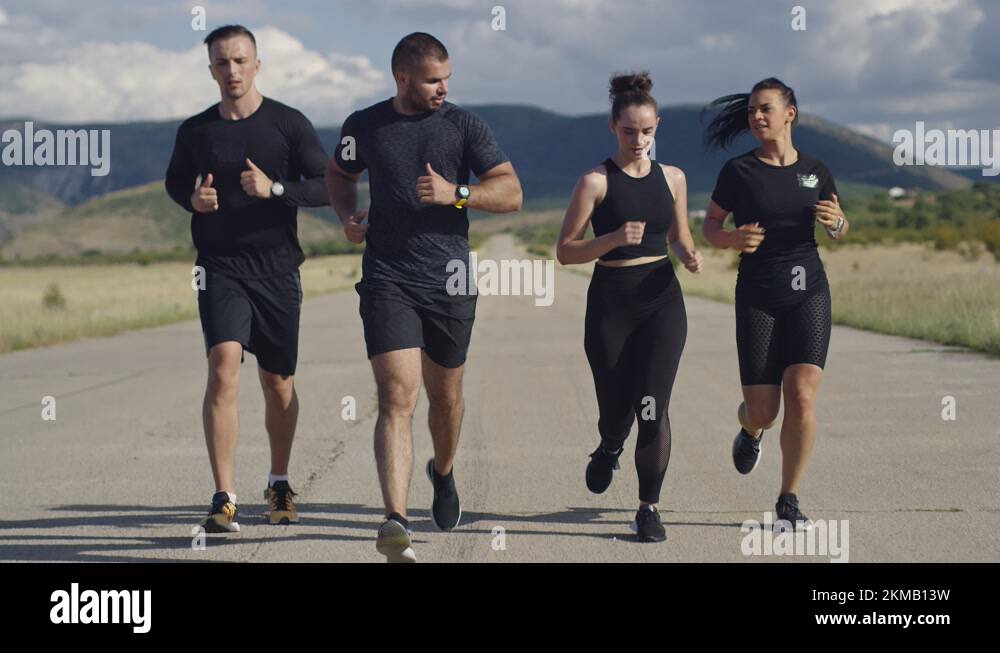 Multiethnic group of athletes running together on a panoramic ...