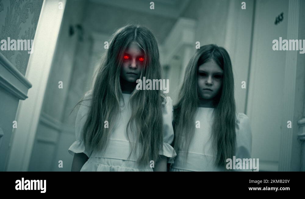 Two creepy little girls with scary evil eyes standing in hotel hall ...