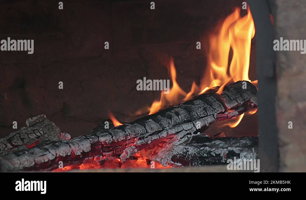 Firey burning wooden logs inside rustic pizza oven. Dying fire flames ...