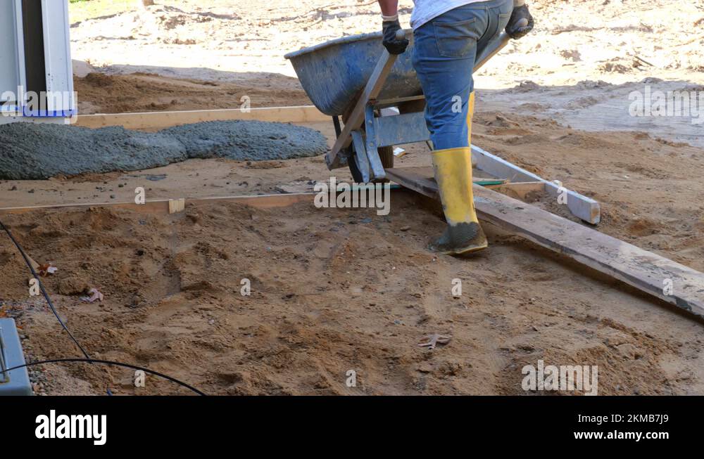 CROW WING CO, MN - 4 MAY 2021: Two workers with wheelbarrows of ...