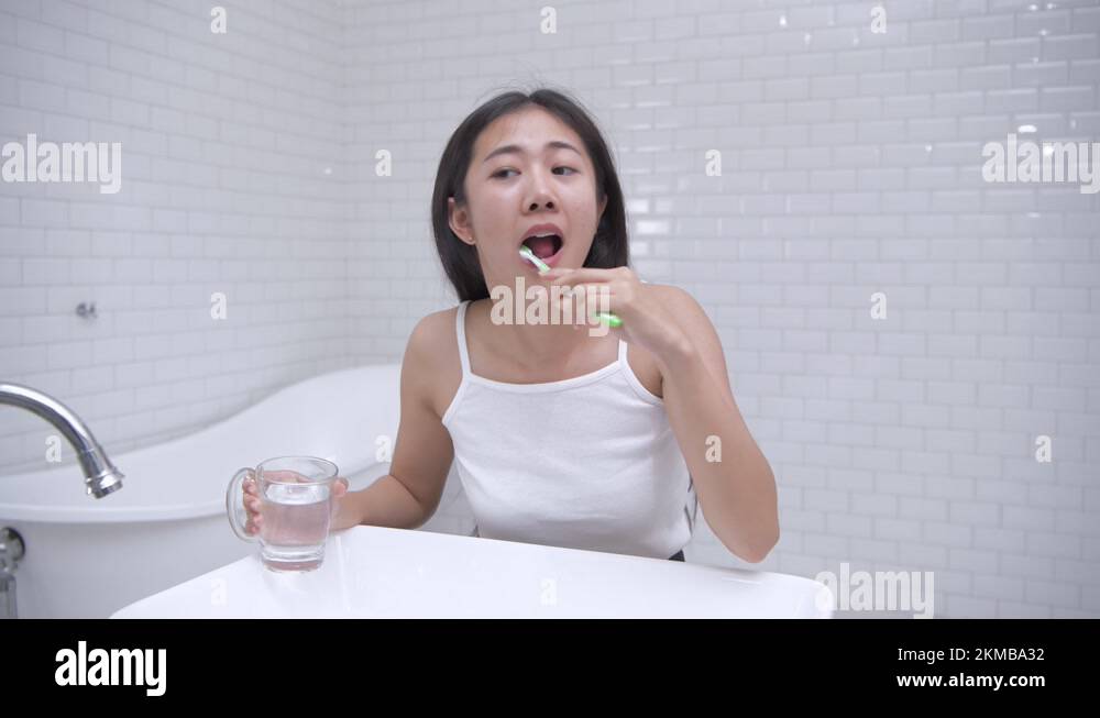 Daily routine concept of 4k Resolution. Asian woman brushing teeth in ...