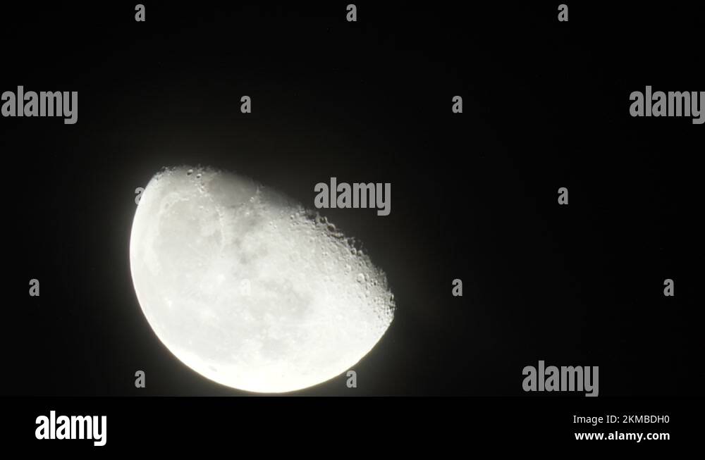 Bright moon move across night sky, light clouds fly over, time lapse ...