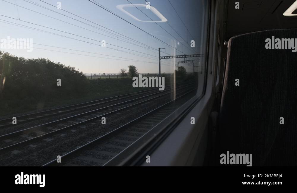 Looking out the window of high speed train at english countryside early ...