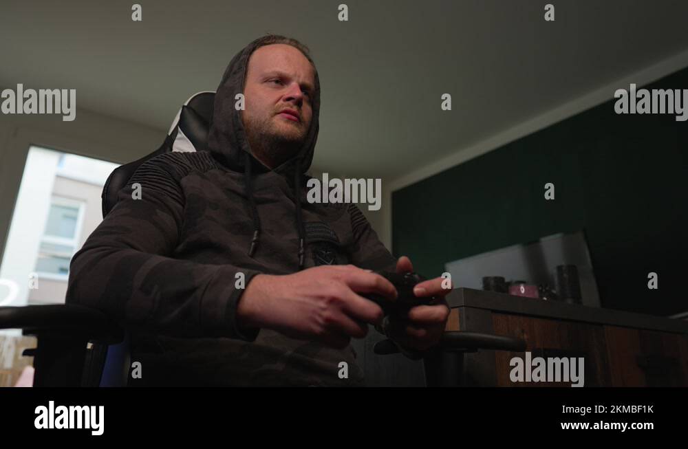 VIDEO GAMES - Man talking while playing Xbox game, low angle medium ...