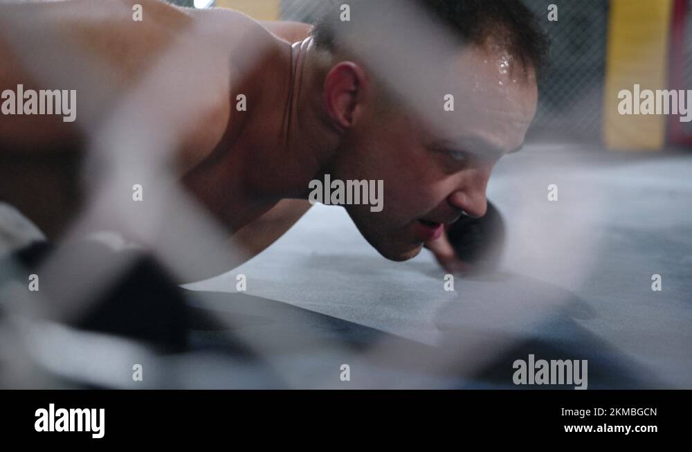 MMA fighter is falling on the floor after being hit and gets up quickly ...