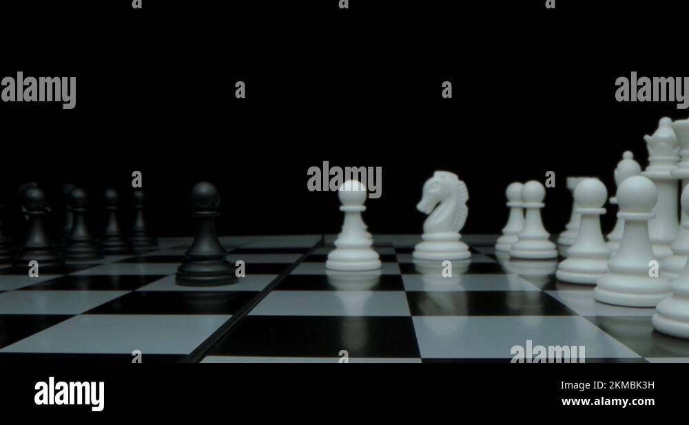 Game of chess. Filmed in a dark key. Black moves and takes the white ...