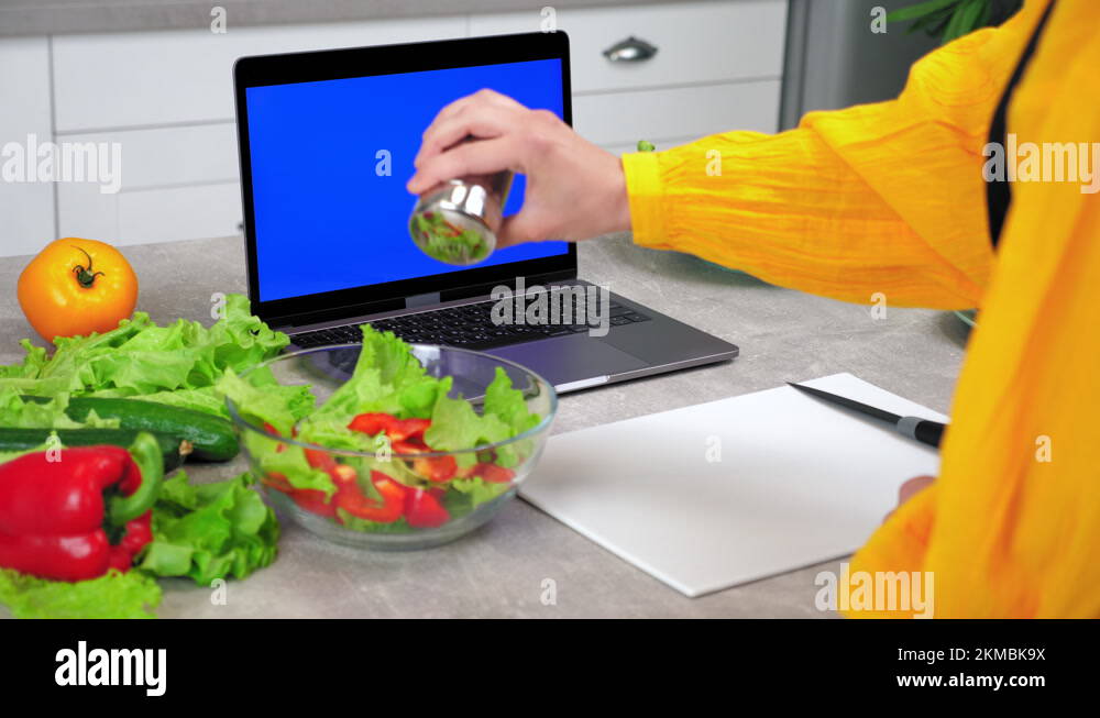 Blue screen laptop: Woman salt cooked vegetarian delicious salad in ...