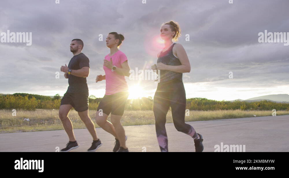 Multiethnic group of athletes running together on a panoramic ...