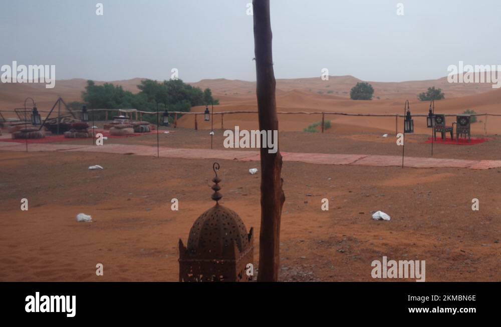Rain and storm in the Sahara desert, seen from inside a luxury camp te ...