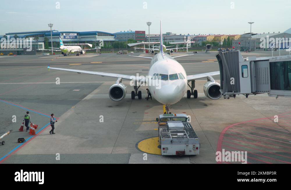 Ground Crews Removing Safety Cones And Chocks From Parked Airplane ...