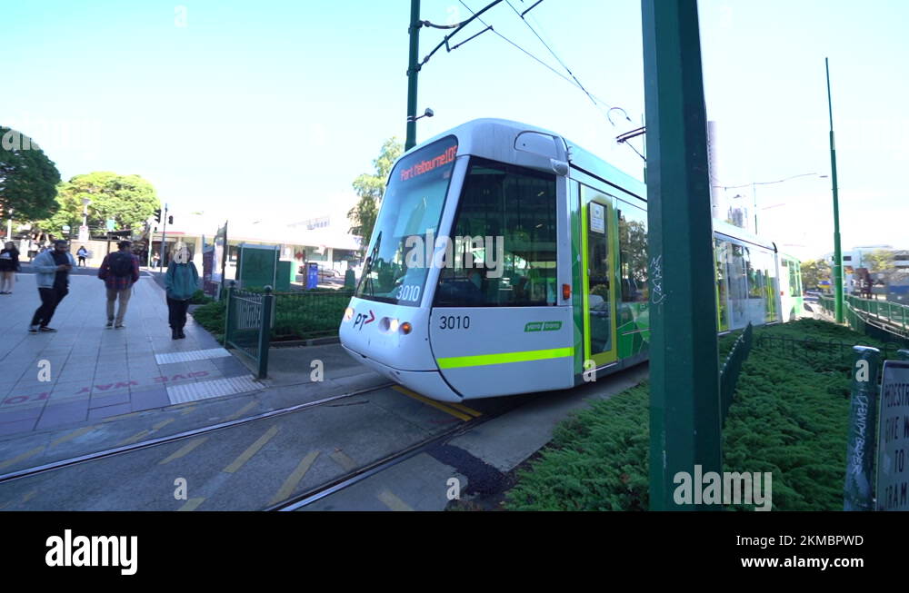 Modern tram crossing people path in gimbal moving back shot Stock Video ...