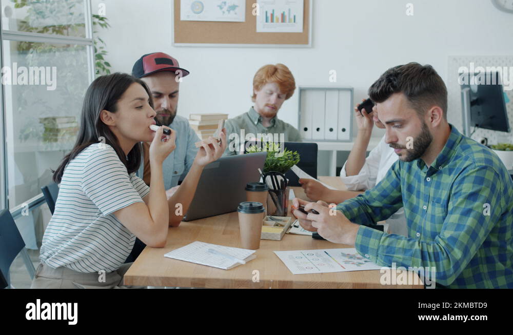 Lazy bored employees playing mobile games flying paper planes and ...