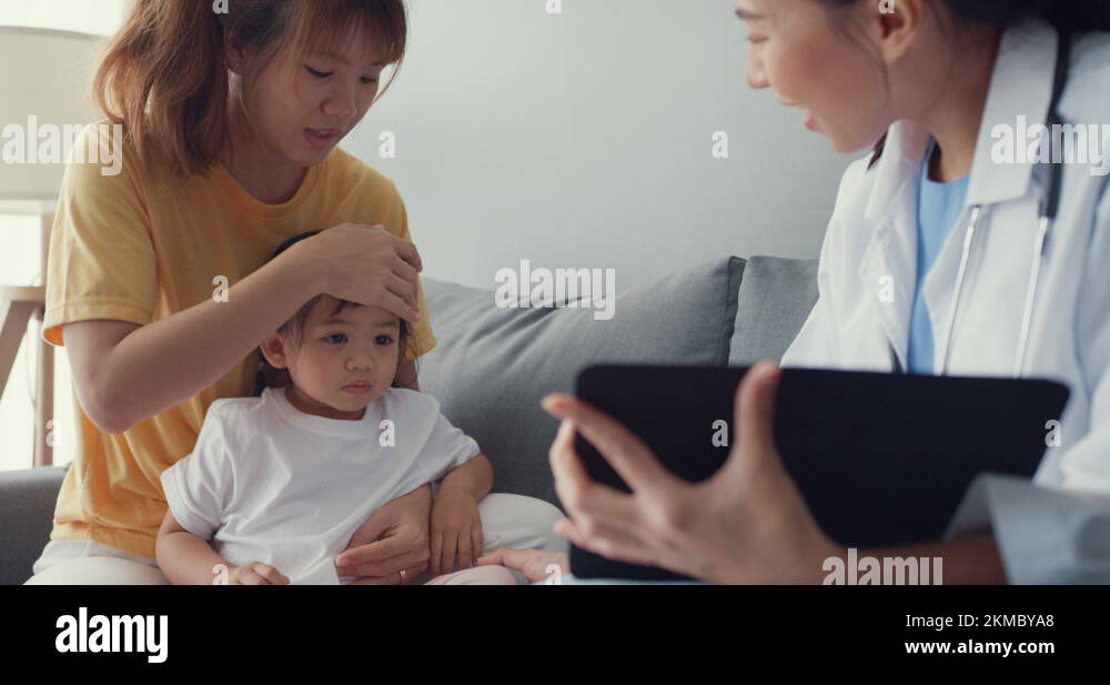 Young Asia female pediatrician doctor and little girl patient using ...