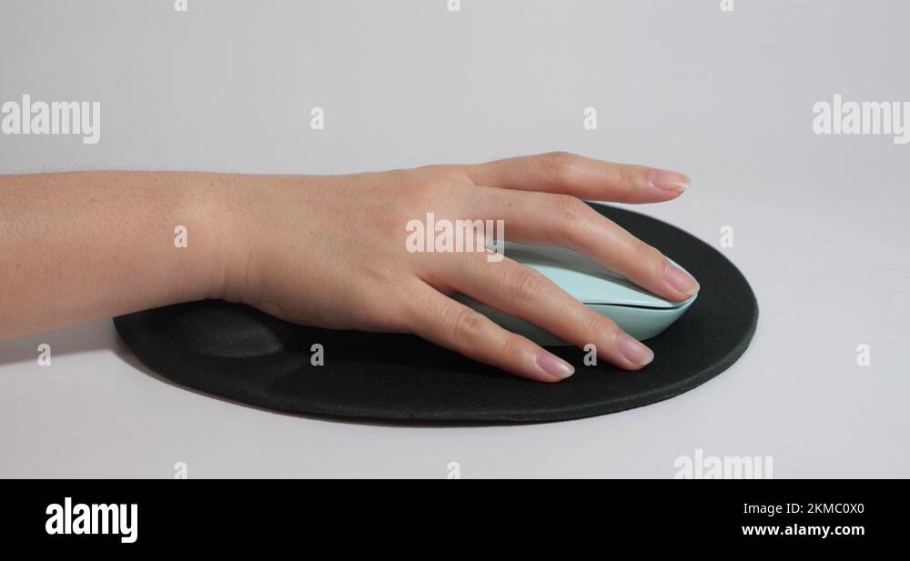 Close-up of hand woman moves the mouse working the computer on white ...