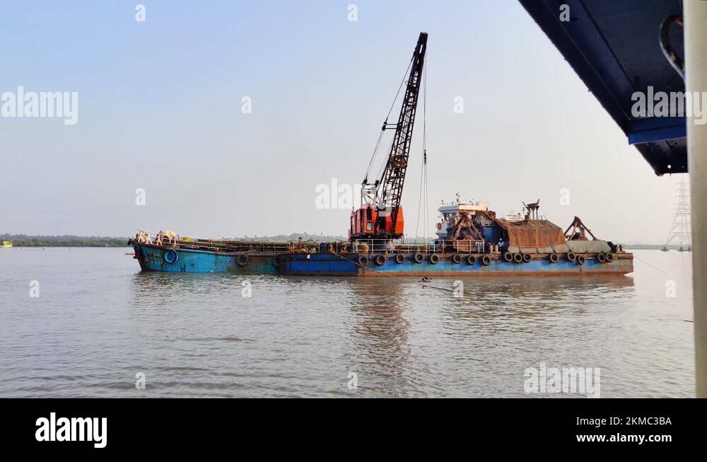 Mining or cleaning trash from bay or Ocean with a big ship crane digger ...