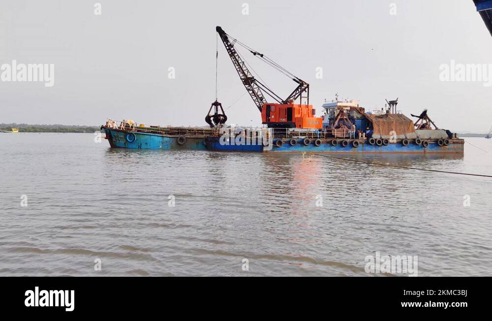 Mining or cleaning trash from bay or Ocean with a big ship crane digger ...