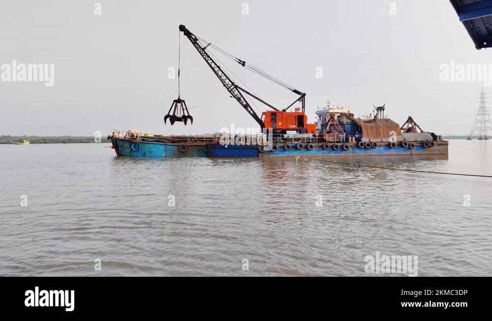 Mining or cleaning trash from bay or Ocean with a big ship crane digger ...