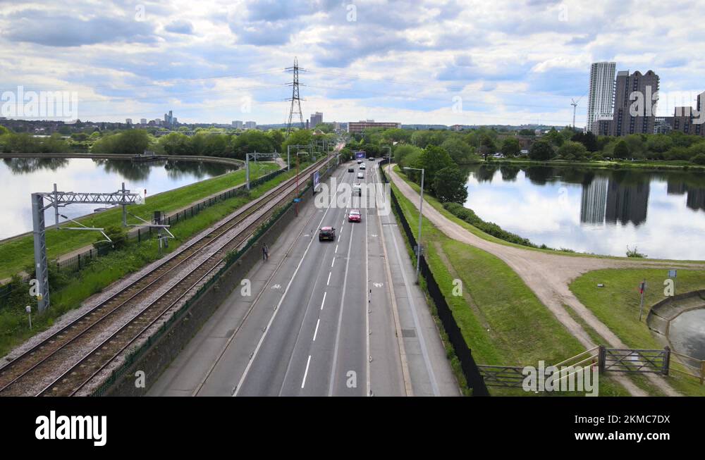 Car driving on wide road with bike lanes and sidewalks leading between ...