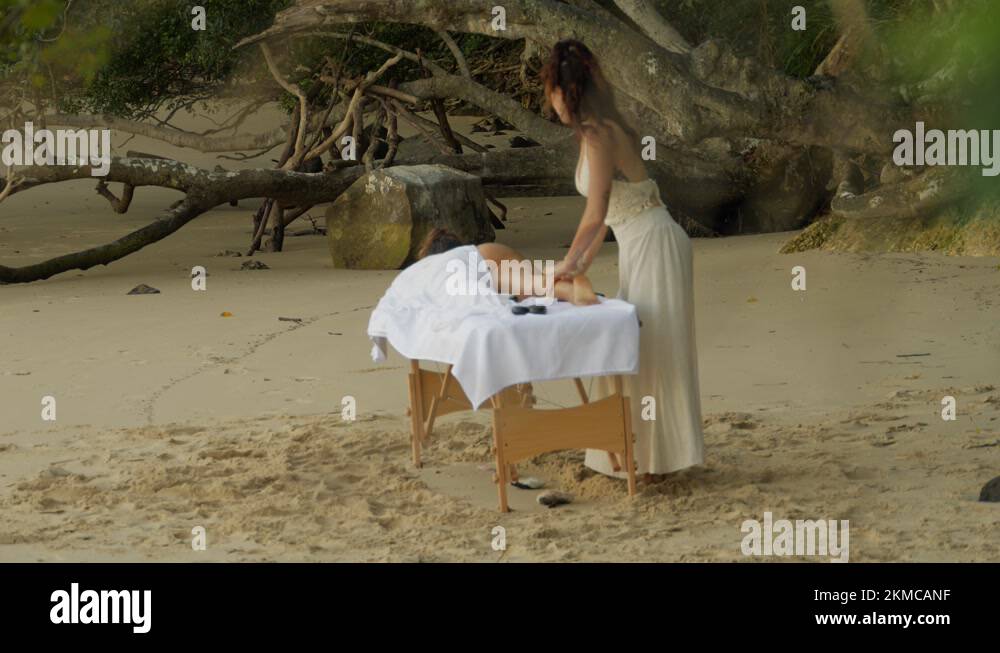 Massage Therapist Applying Effleurage On The Leg Of Her Client. static ...