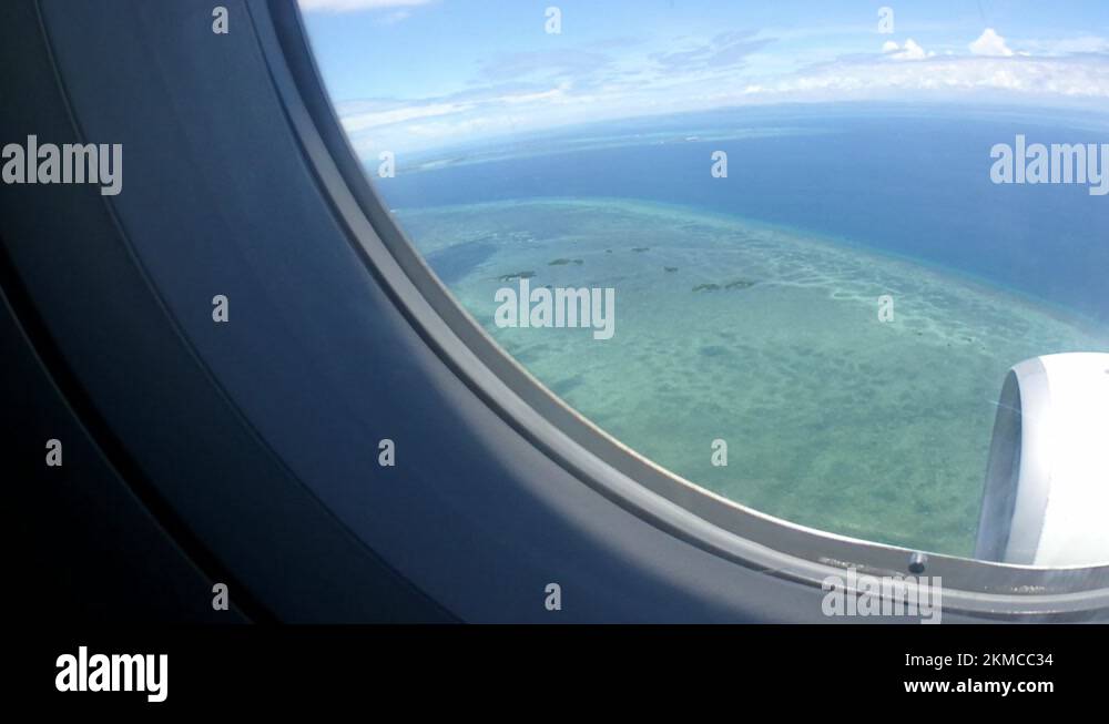 Airplane window view, a travel to Southeast Asia; a flight passing by ...