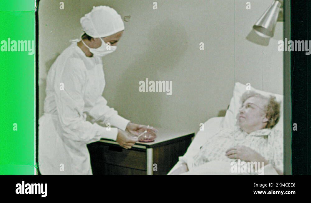 1960s: Masked nurse swabs female patient's nose. Petri dish labeled ...