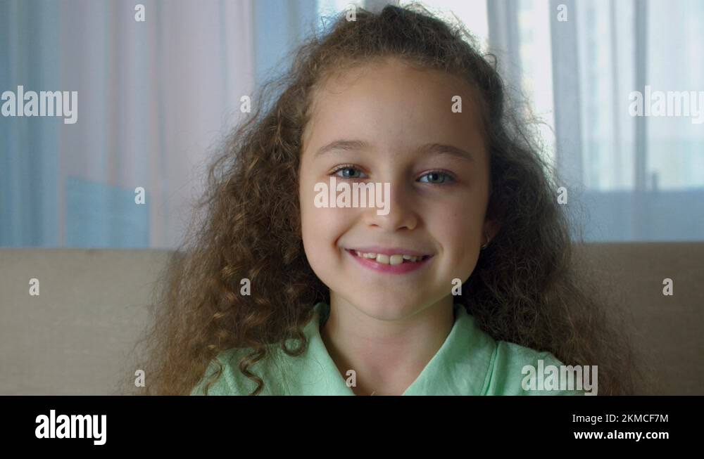 Portrait Honey little girl smiling child looking at camera are sitting ...