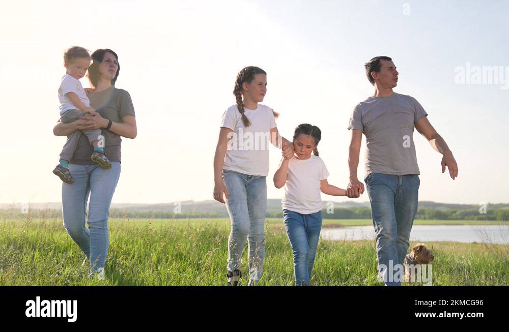 Happy family. Hiking in park. Happy cute family walking in nature park ...