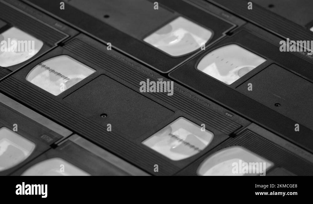 Memories evoking background of real VHS cassettes sliding up, black and ...