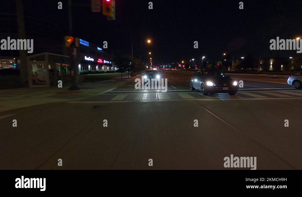POV driving plate reverse shot roads and highways on a very dark night ...