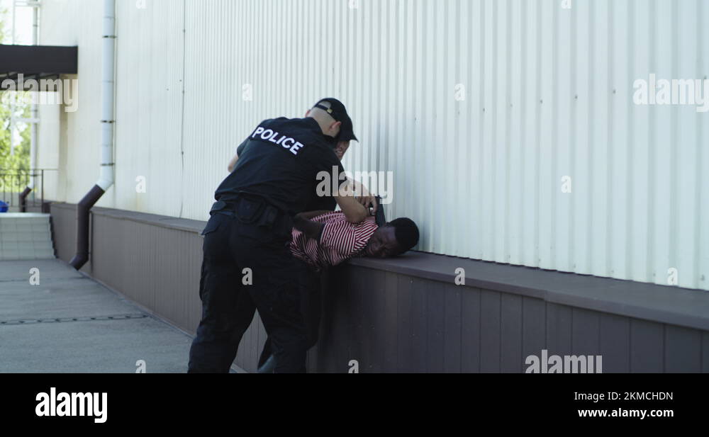Black man running away from police officers Stock Video Footage - Alamy