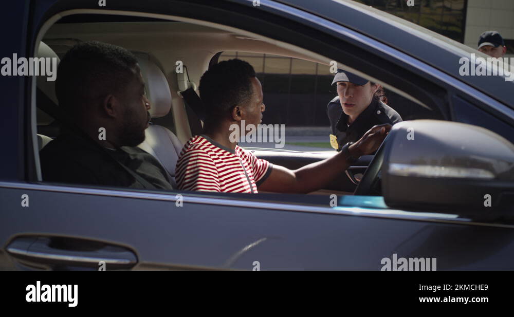 Police officer checking digital driver license of black man Stock Video ...